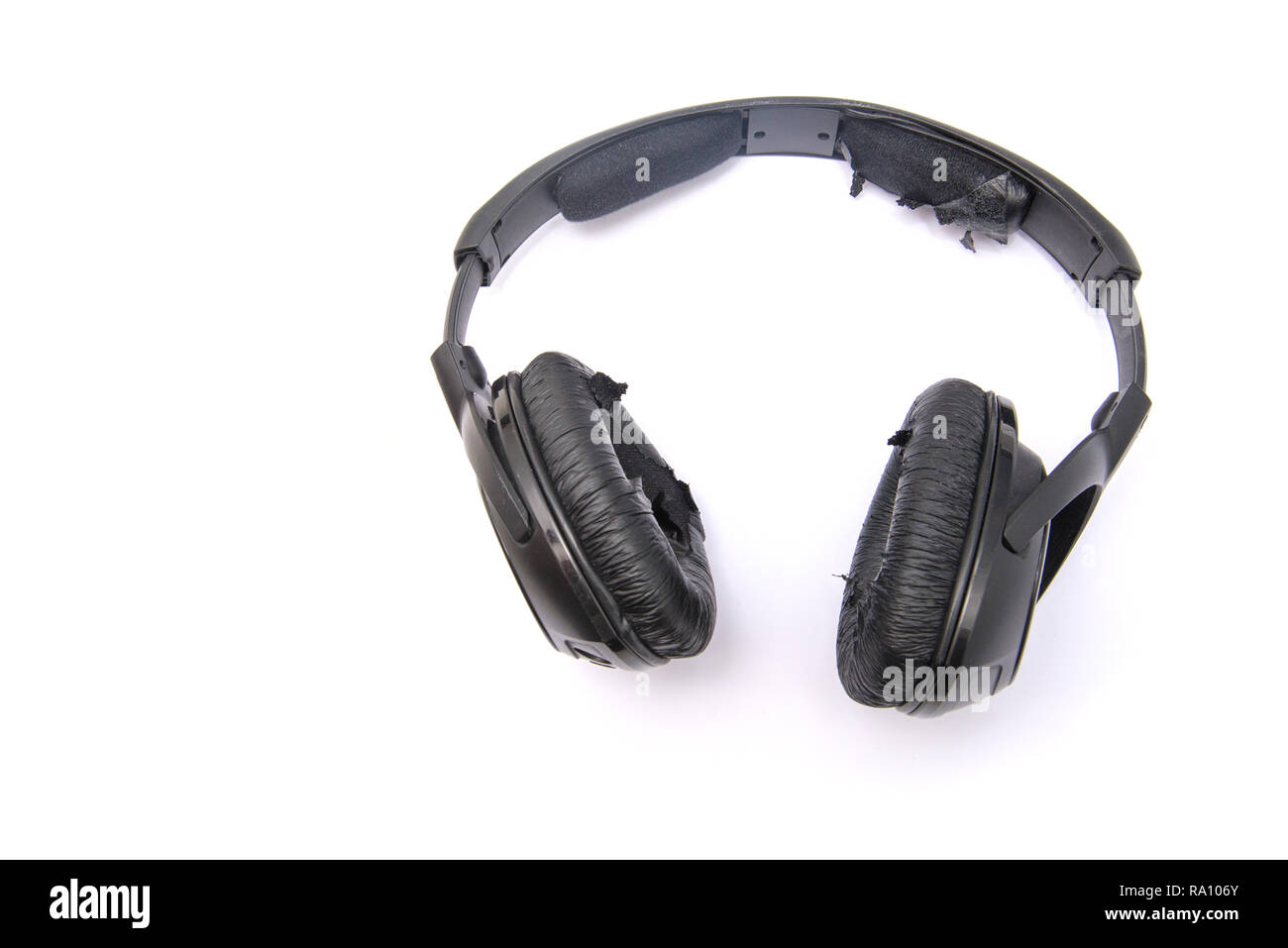 Old shabby earphones on a white background. Worn headphones wirelessly ...