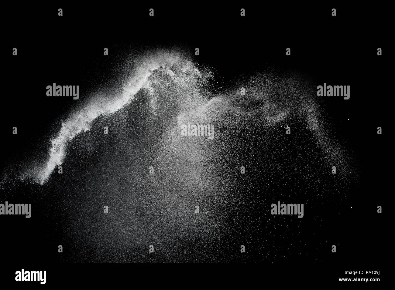 Launched white powder splash on black background Stock Photo - Alamy