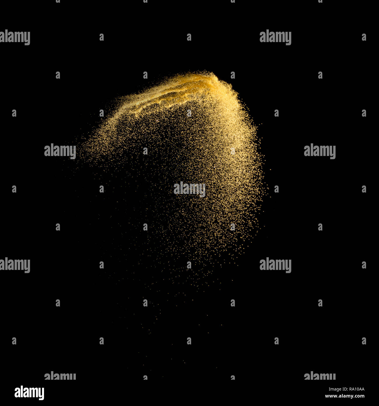 Golden sand explosion isolated on black background. Abstract sand cloud ...