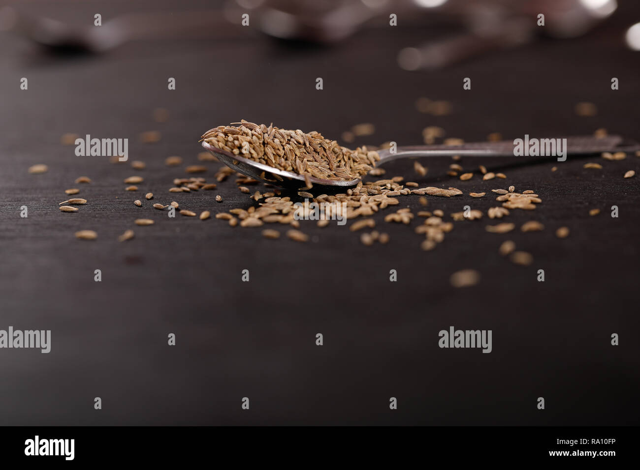 Cumin Seeds on black background Stock Photo - Alamy
