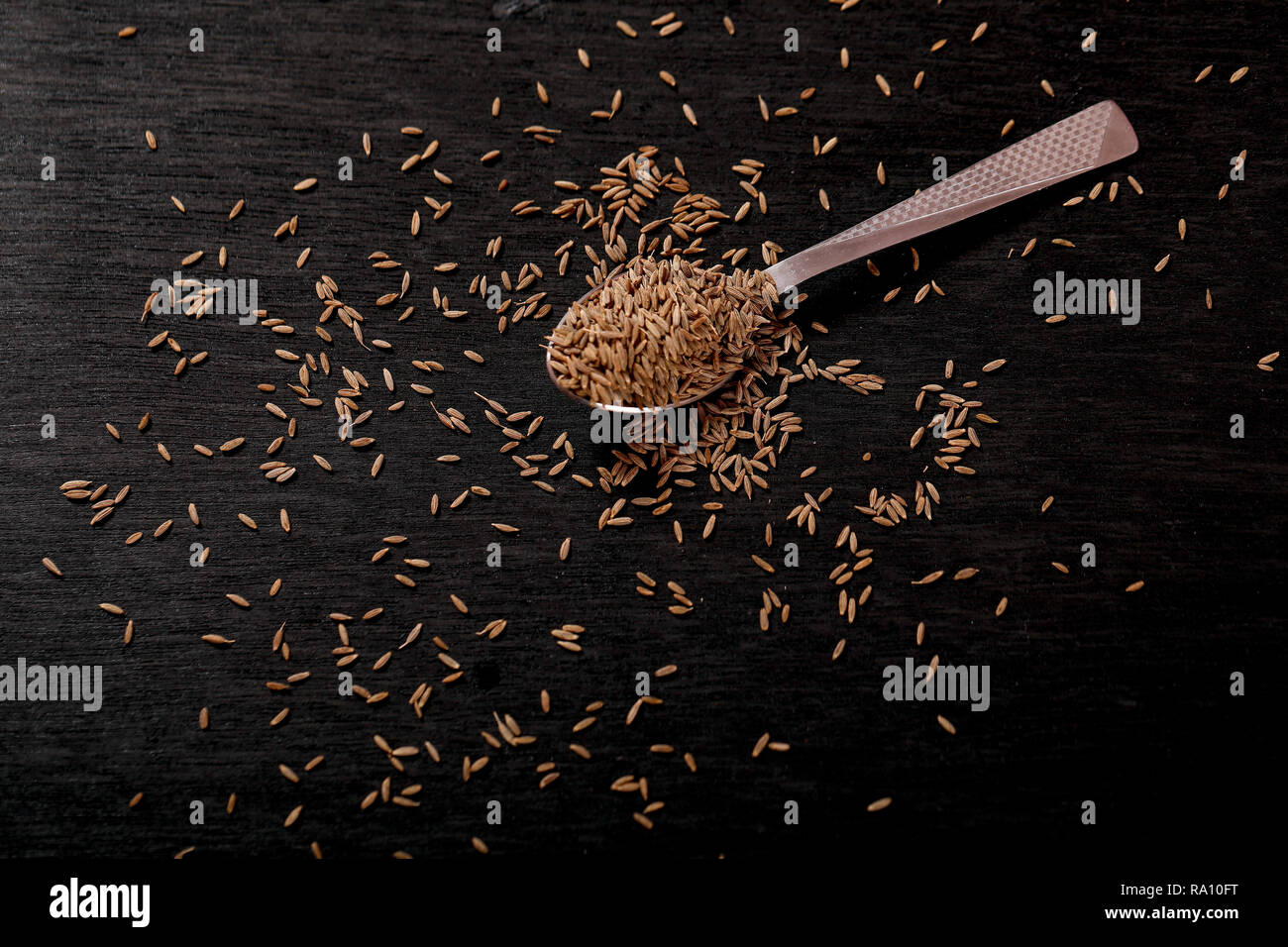 Cumin Seeds on black background Stock Photo - Alamy