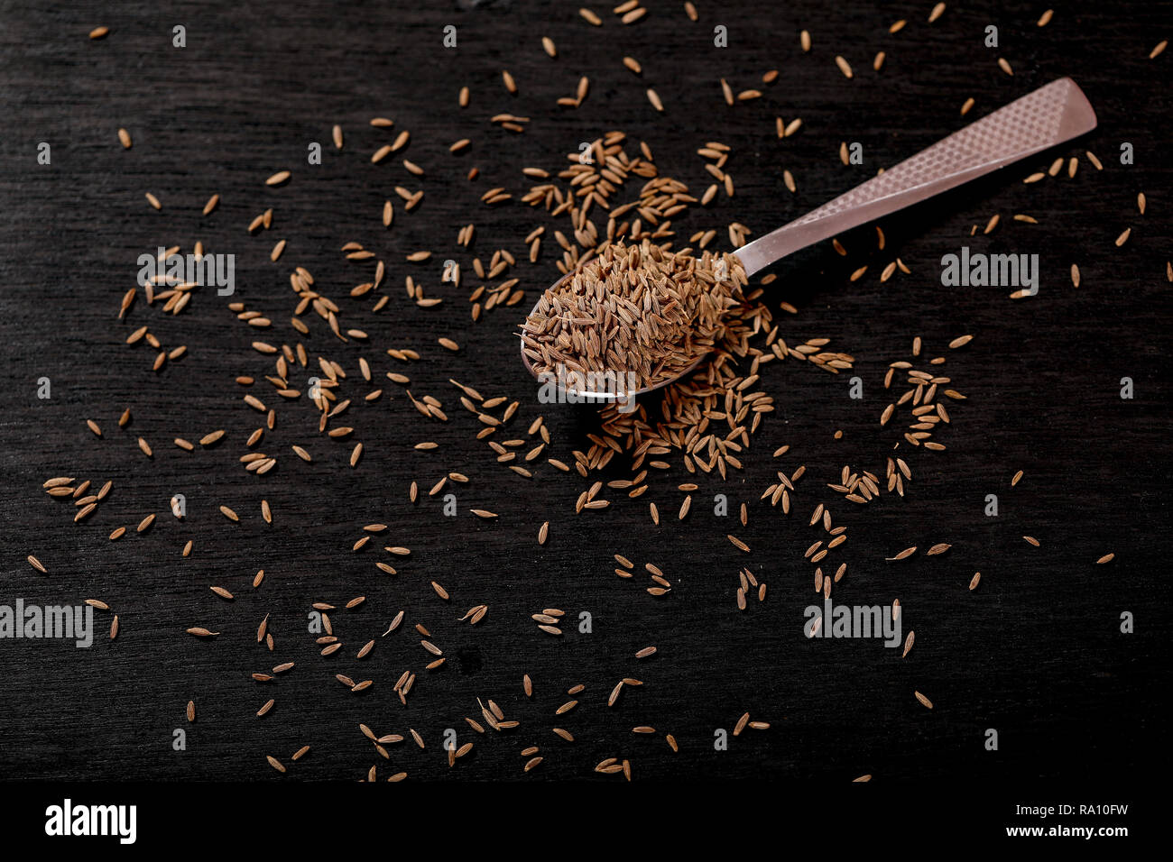 Cumin Seeds on black background Stock Photo - Alamy