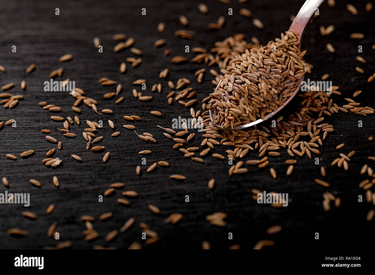 Cumin Seeds on black background Stock Photo - Alamy