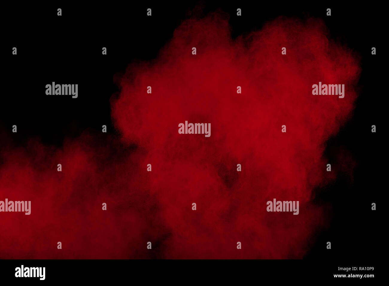 red color powder explosion cloud on black background Stock Photo - Alamy