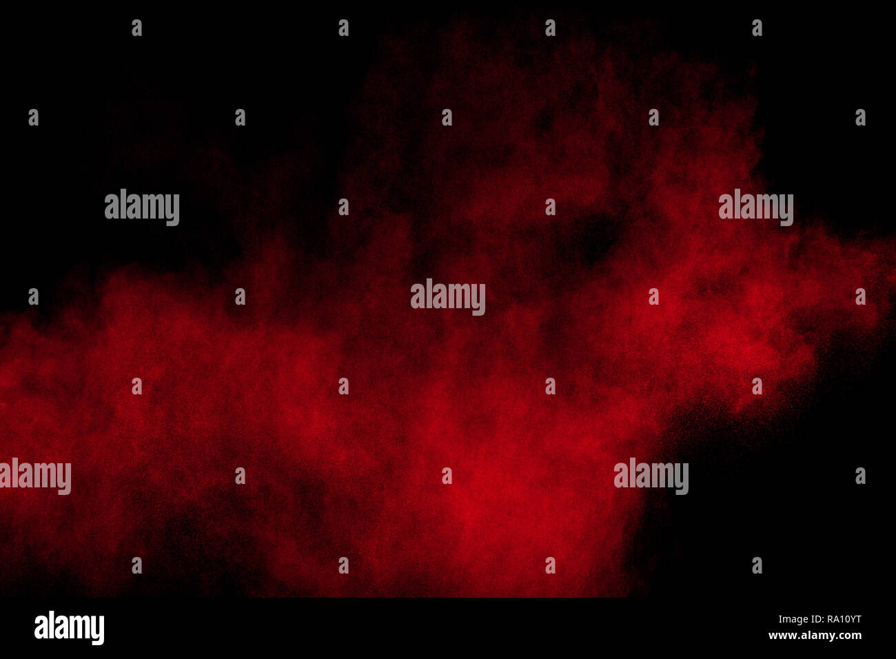 Red powder explosion on black background. Freeze motion of red dust ...