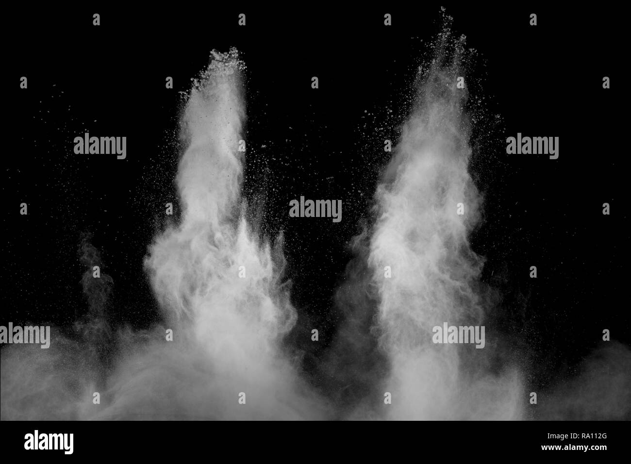 Freeze motion of white dust particles on black background. White powder ...
