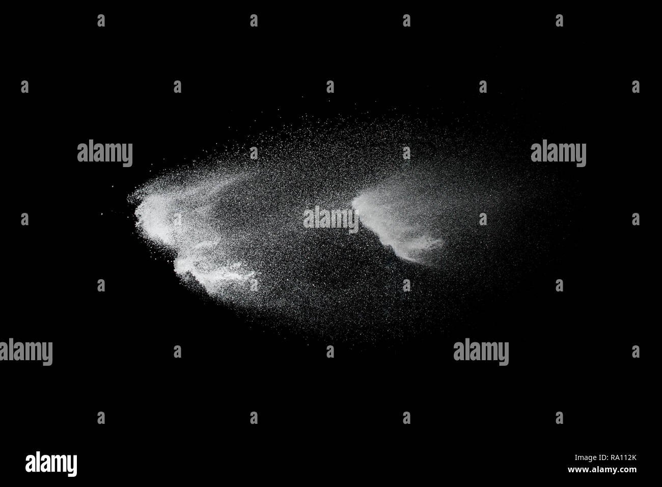 Freeze motion of white dust particles on black background. White powder ...