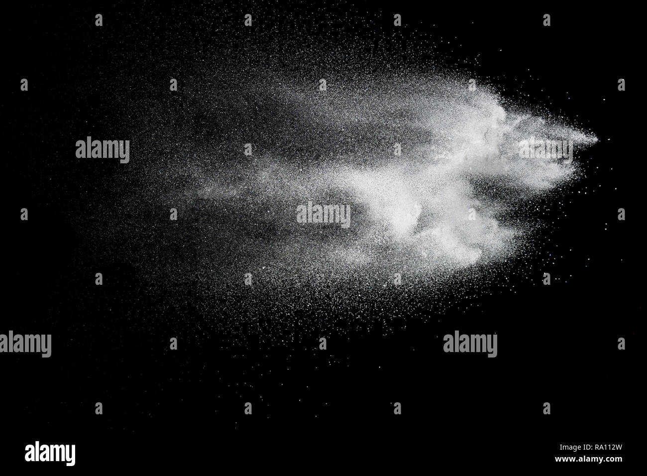 Freeze motion of white dust particles on black background. White powder ...