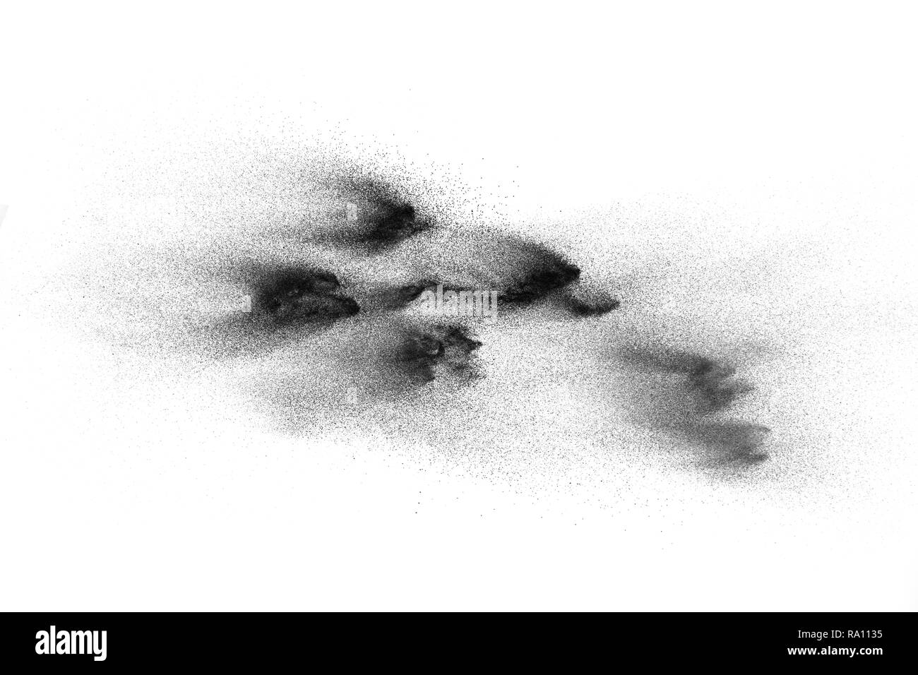 Black particles splattered on white background. Black powder dust ...