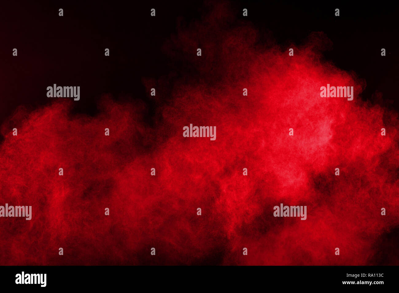 Red color powder explosion on black background.Freeze motion of red ...