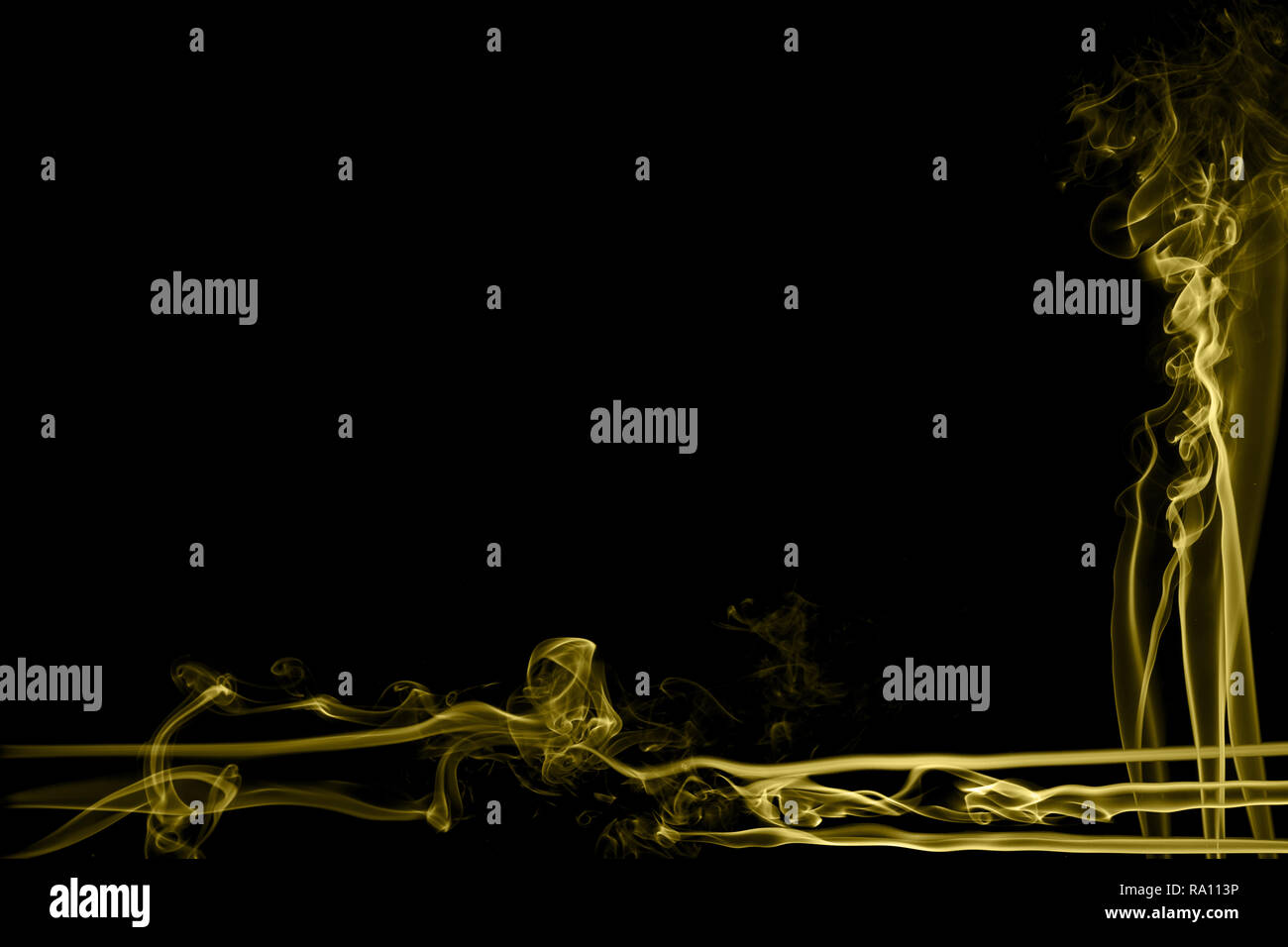 Abstract yellow colored smoke flowed on black background. . Abstract ...