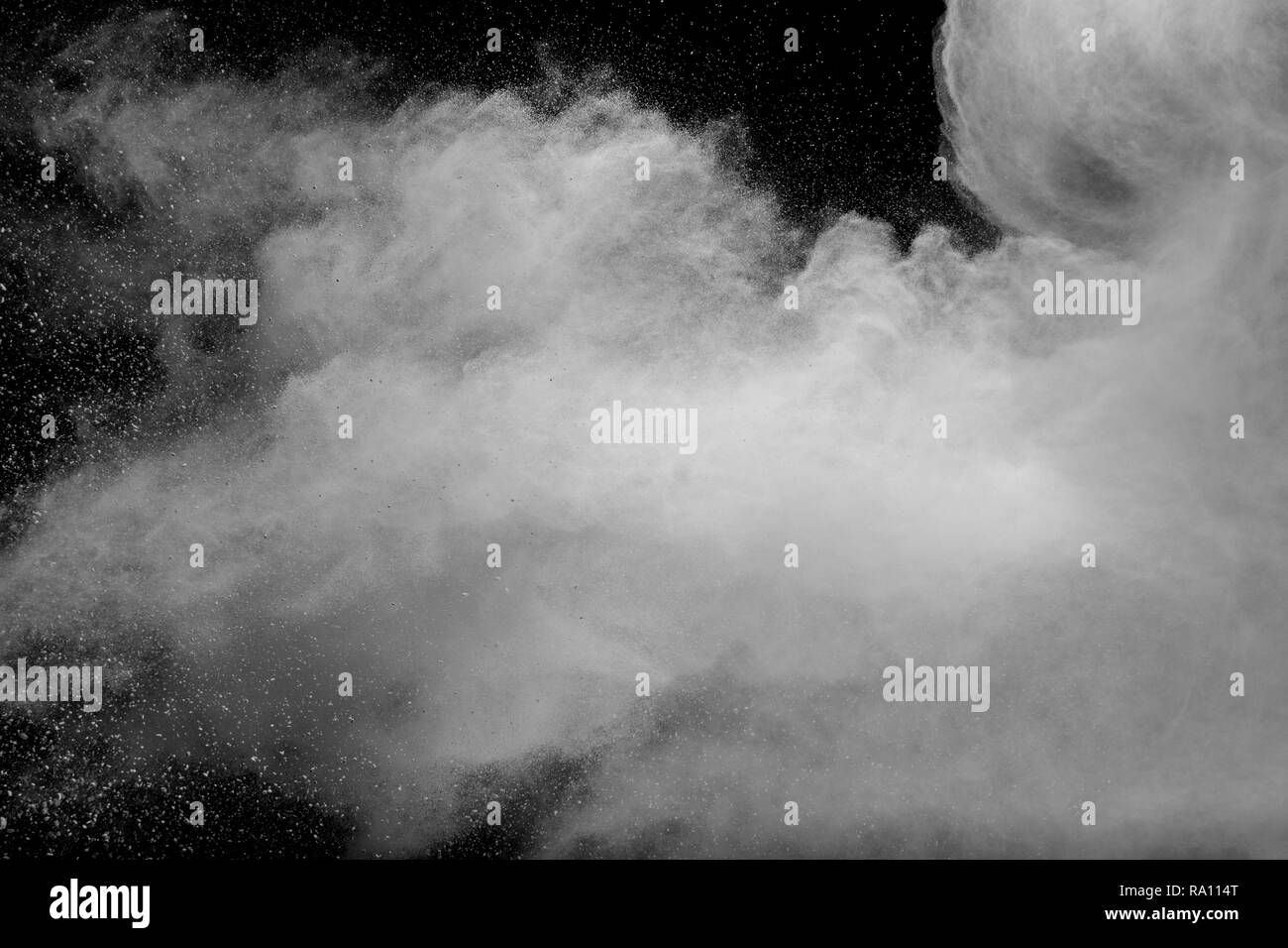 Bizarre forms of white powder explosion cloud against black background ...