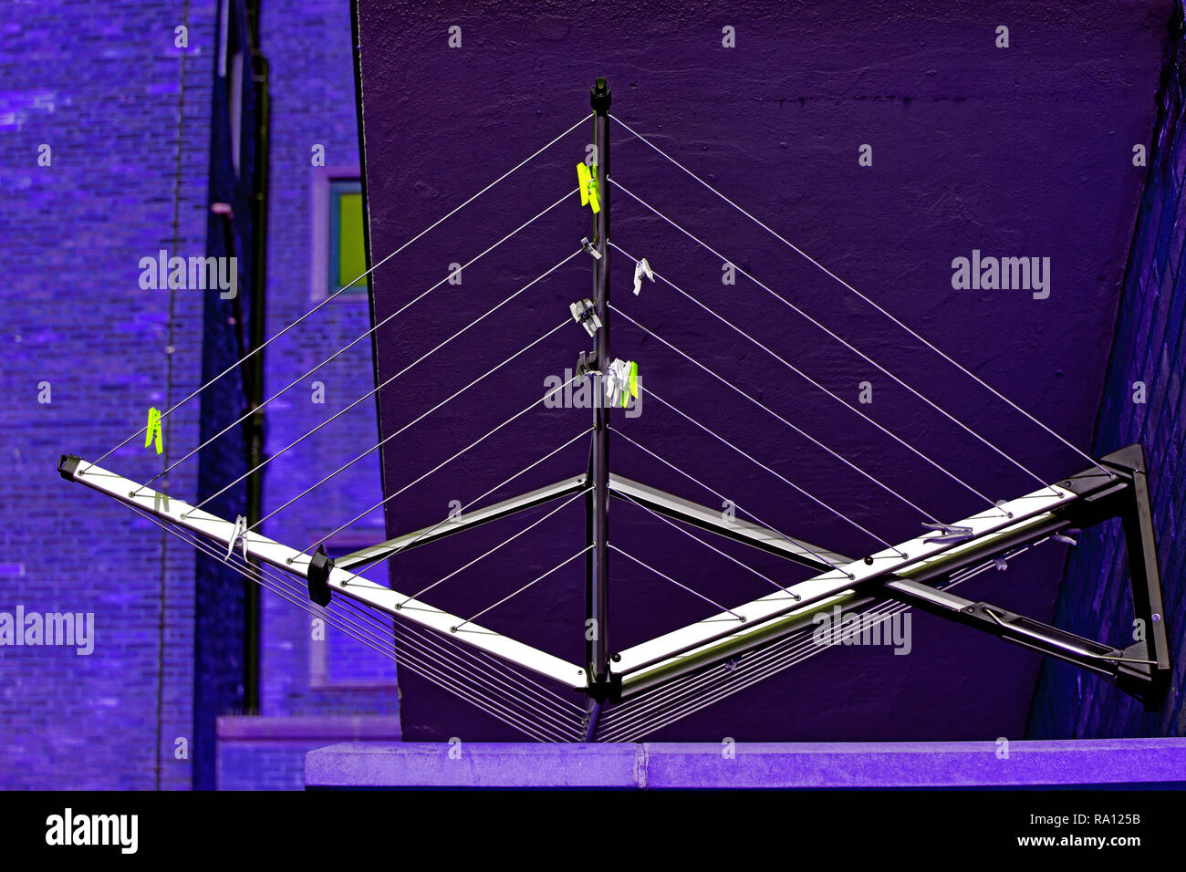 Clothes drying lines and pegs in blue Stock Photo - Alamy