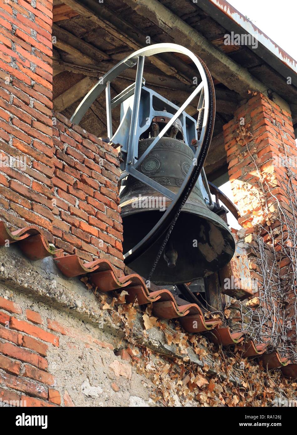 ancient brick bell tower with the historic large bronze bell Stock ...
