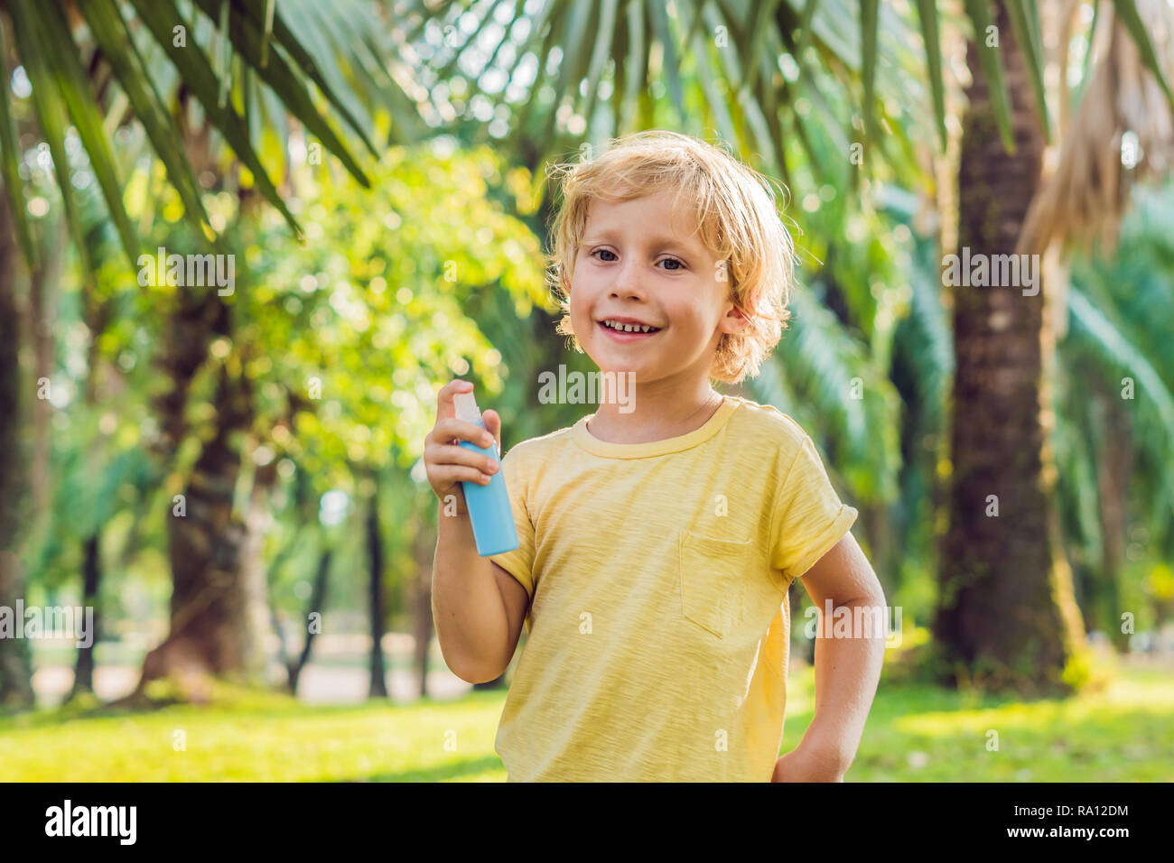 Boy spraying insect repellents on skin Stock Photo - Alamy