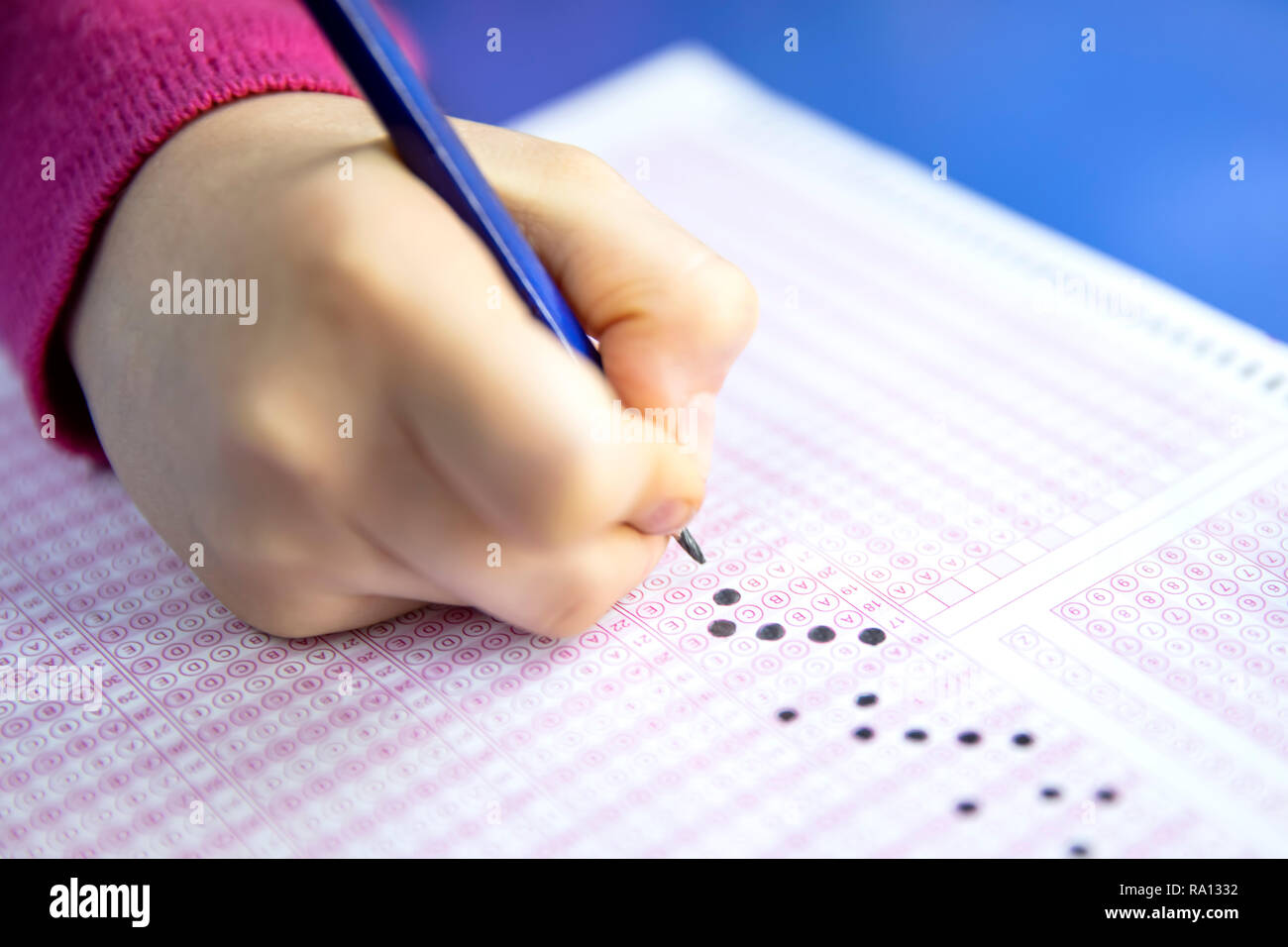 Pencil drawing selected choice on answer sheets. hand fill in Exam ...