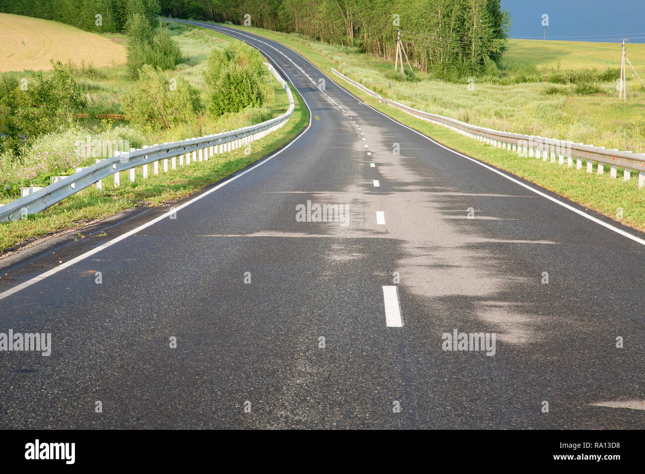 wet asphalt road after a rain Stock Photo - Alamy