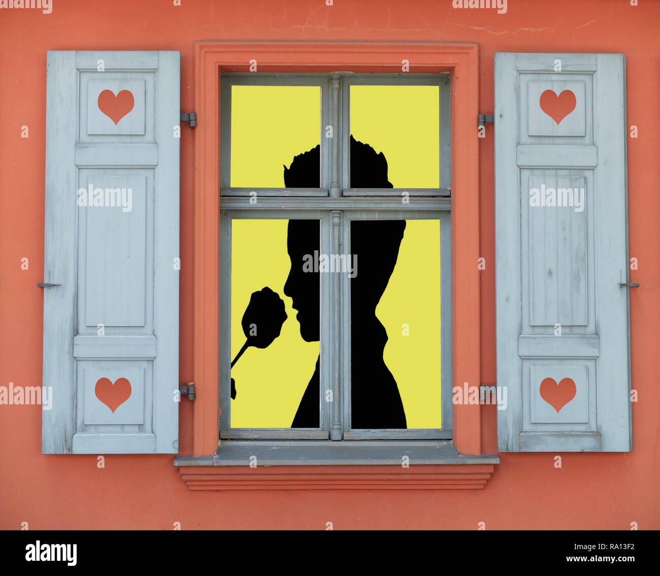 valentines day concept, a lit window with a silhouette of a romantic ...