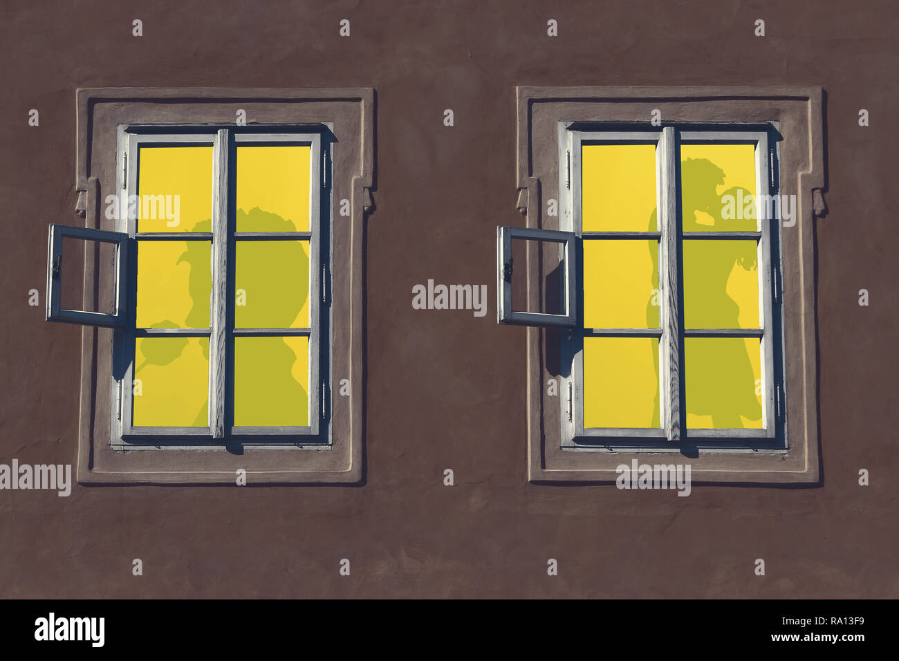 valentines night, two lighted apartment windows with silhouettes of ...