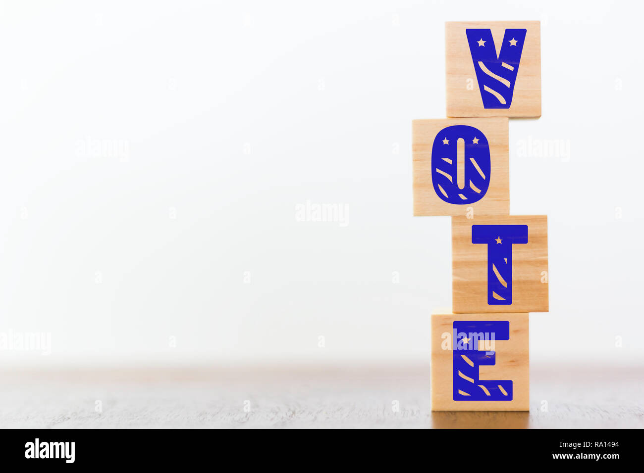 Wooden cubes with vote written against white background Stock Photo - Alamy