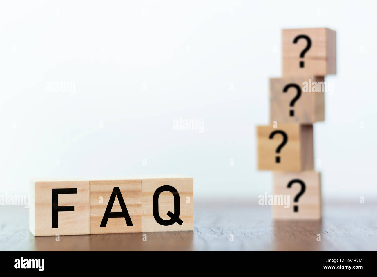 FAQ on wooden blocks with question marks on the background Stock Photo ...