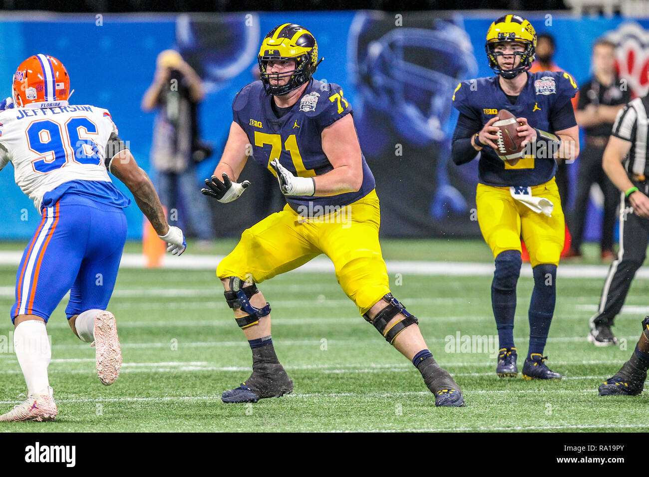 December 29, 2018: Michigan's Shea Patterson (2) is protected by Andrew ...