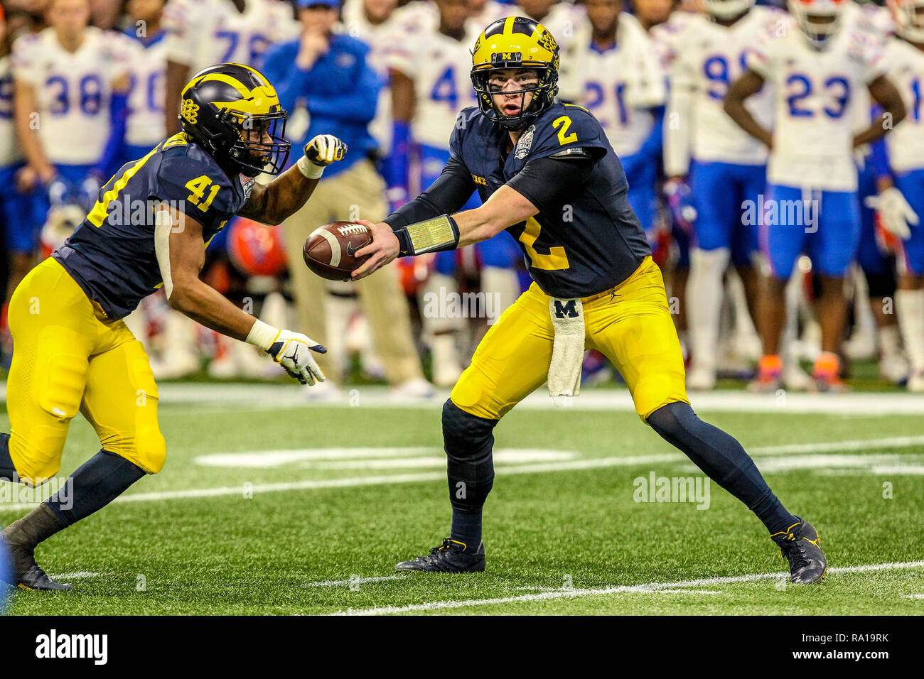 December 29, 2018: Michigan's Shea Patterson (2) hands off to Christian ...