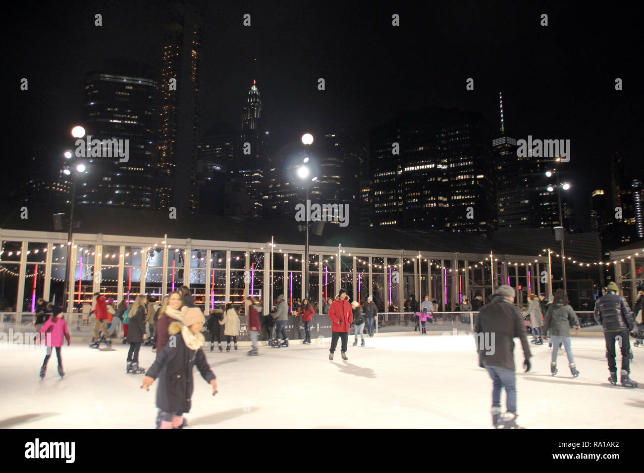 New York, USA. 27th Dec, 2018. Visitors run on the ice rink with a ...