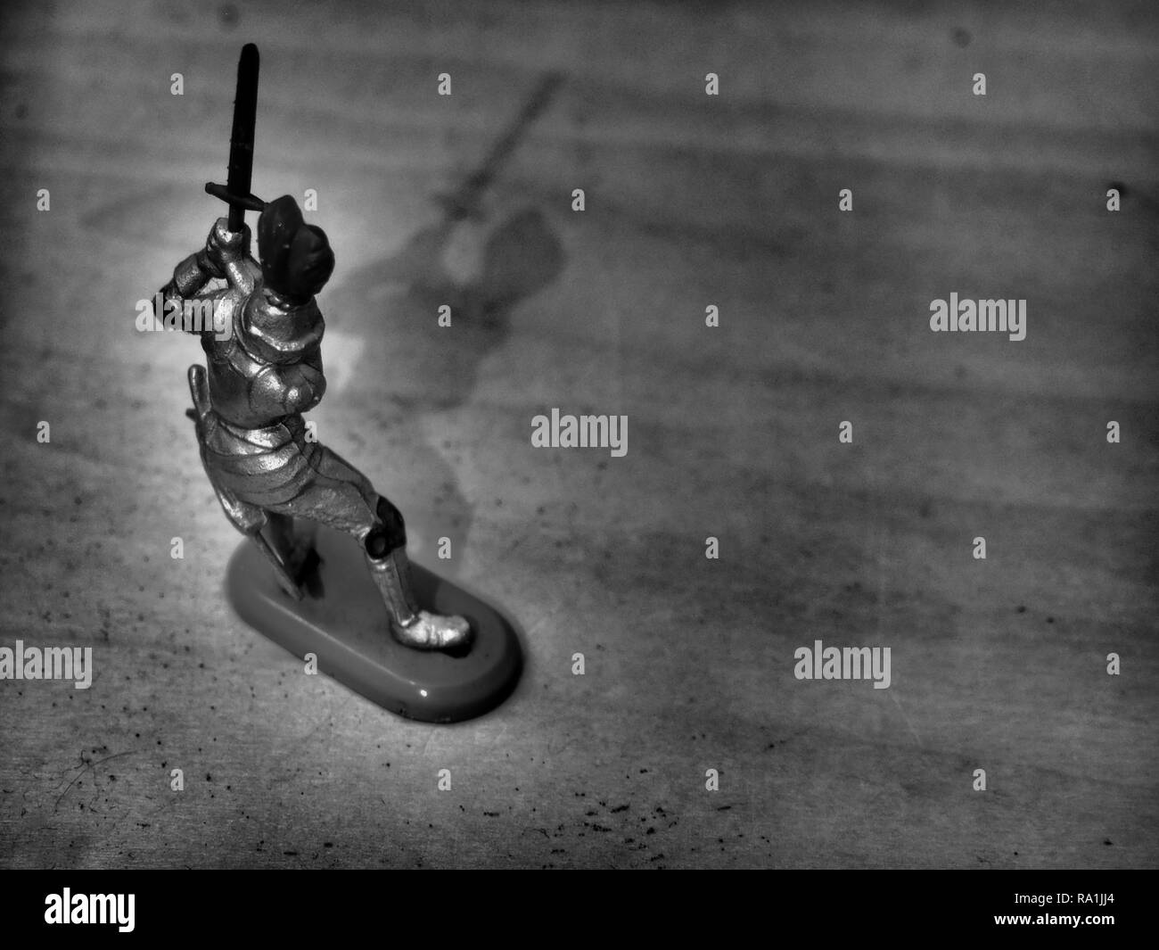 Black and White Image of Knight Wielding Sword on Wooden Table Stock ...