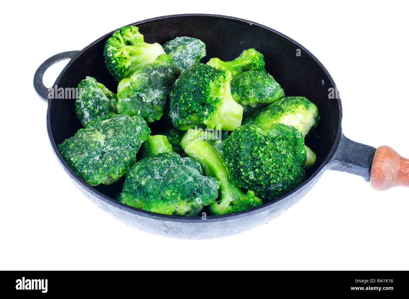 Cast iron pan with frozen broccoli for cooking. Studio Photo Stock ...