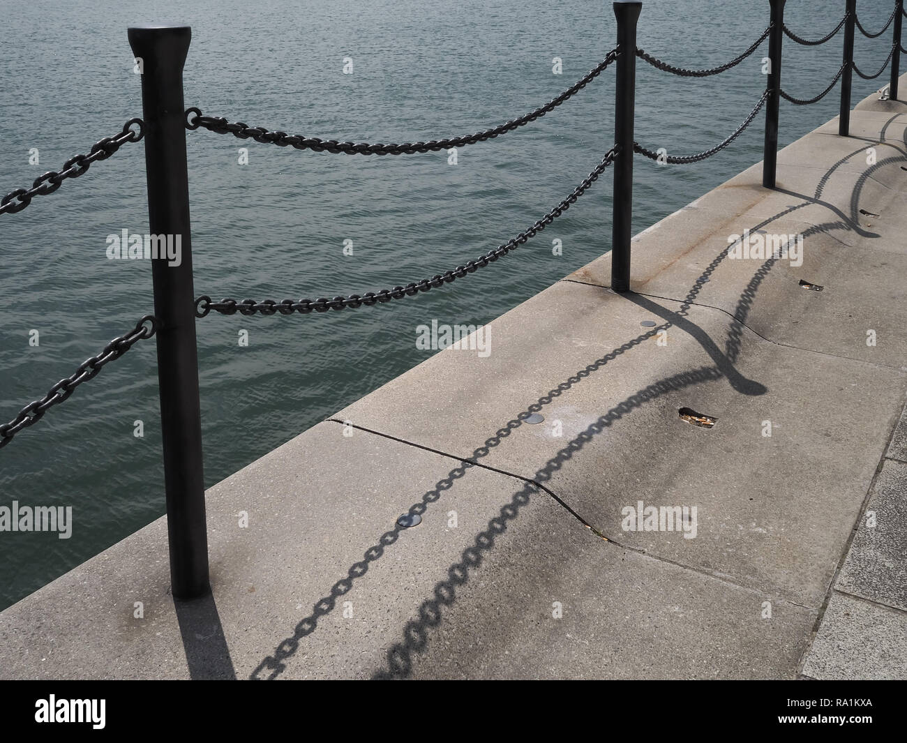 Diagonal metal fence by waterside in London Stock Photo - Alamy