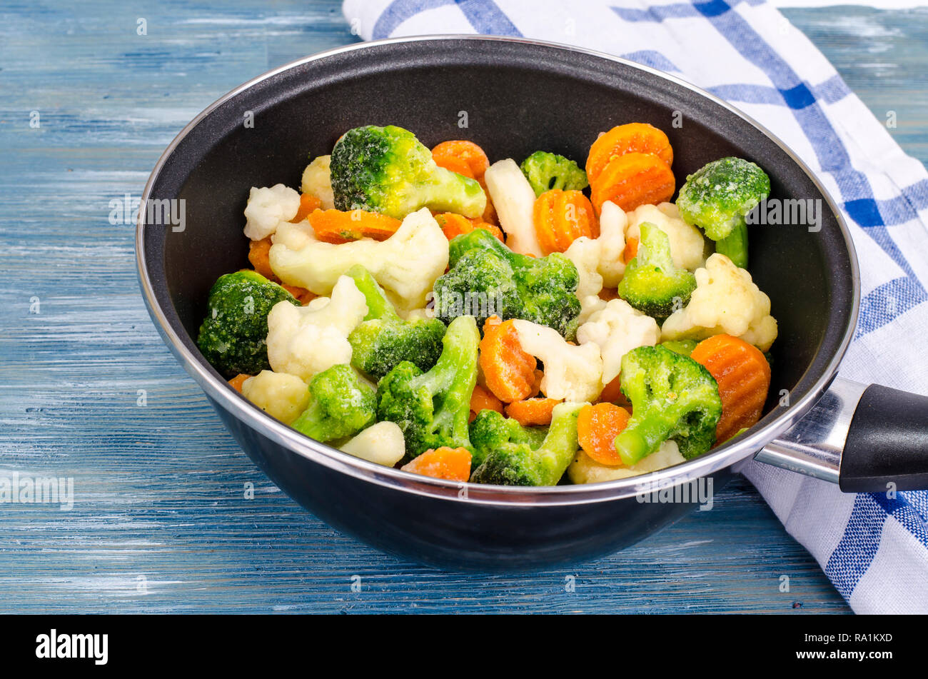 Pan with frozen vegetable mix for frying. Studio Photo Stock Photo - Alamy