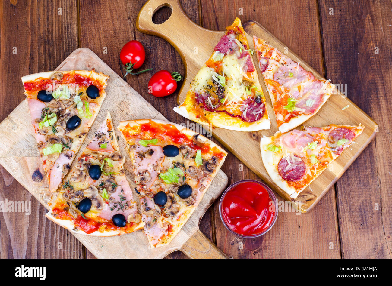 Wooden boards with sliced different pizzas. Studio Photo Stock Photo ...