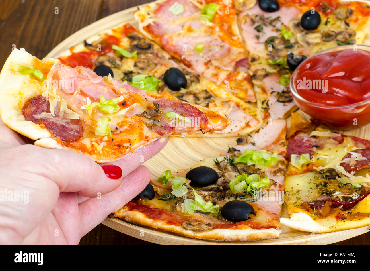 Female hand with slice of pizza. Studio Photo Stock Photo - Alamy