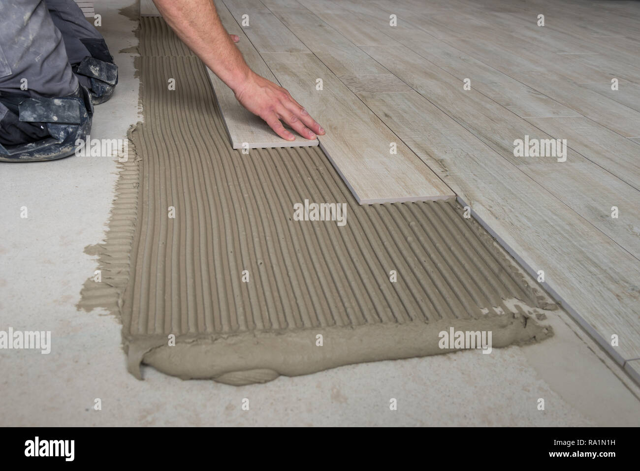 Laying ceramic tiles on hi-res stock photography and images - Alamy