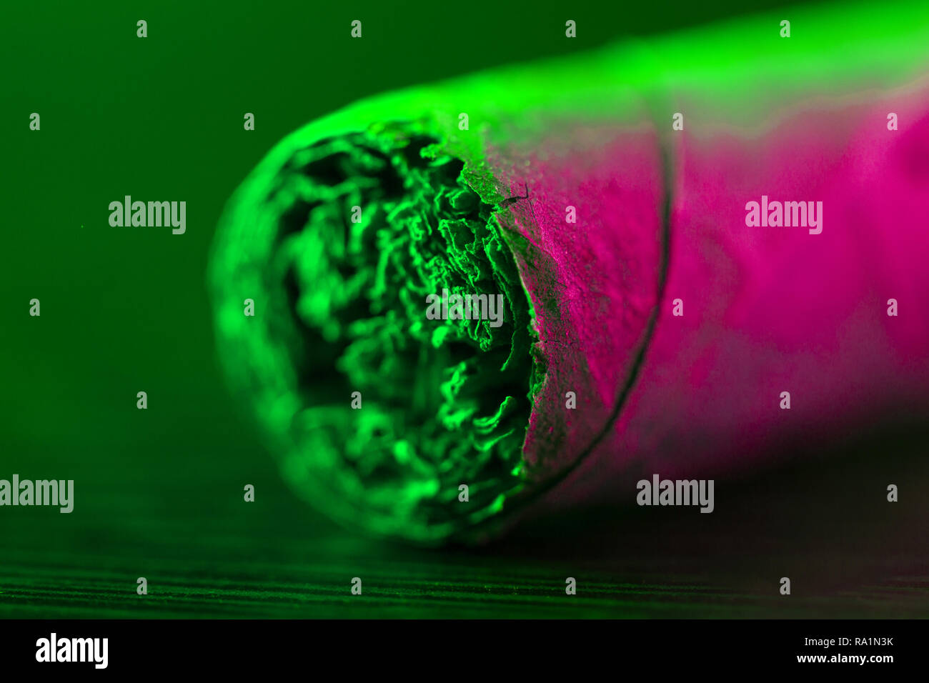 Close up of cigars in neon light Stock Photo - Alamy