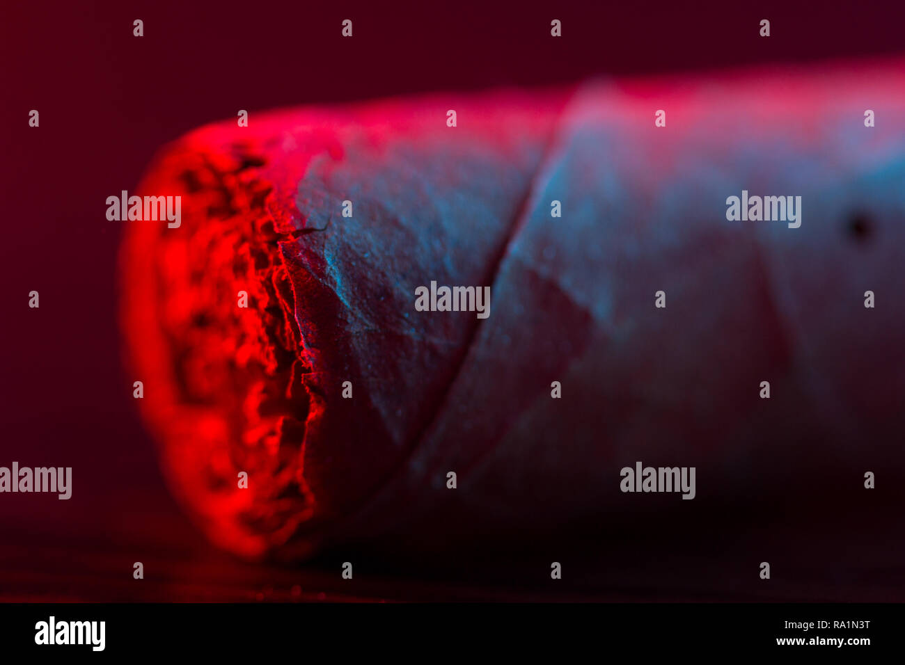 Close up of cigars in neon light Stock Photo - Alamy