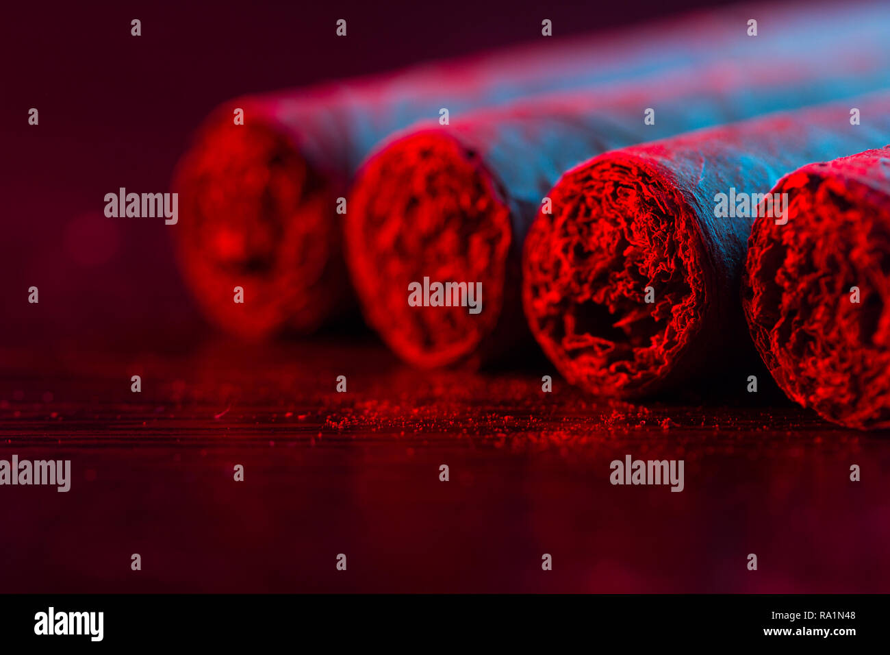 Close up of cigars in neon light Stock Photo - Alamy