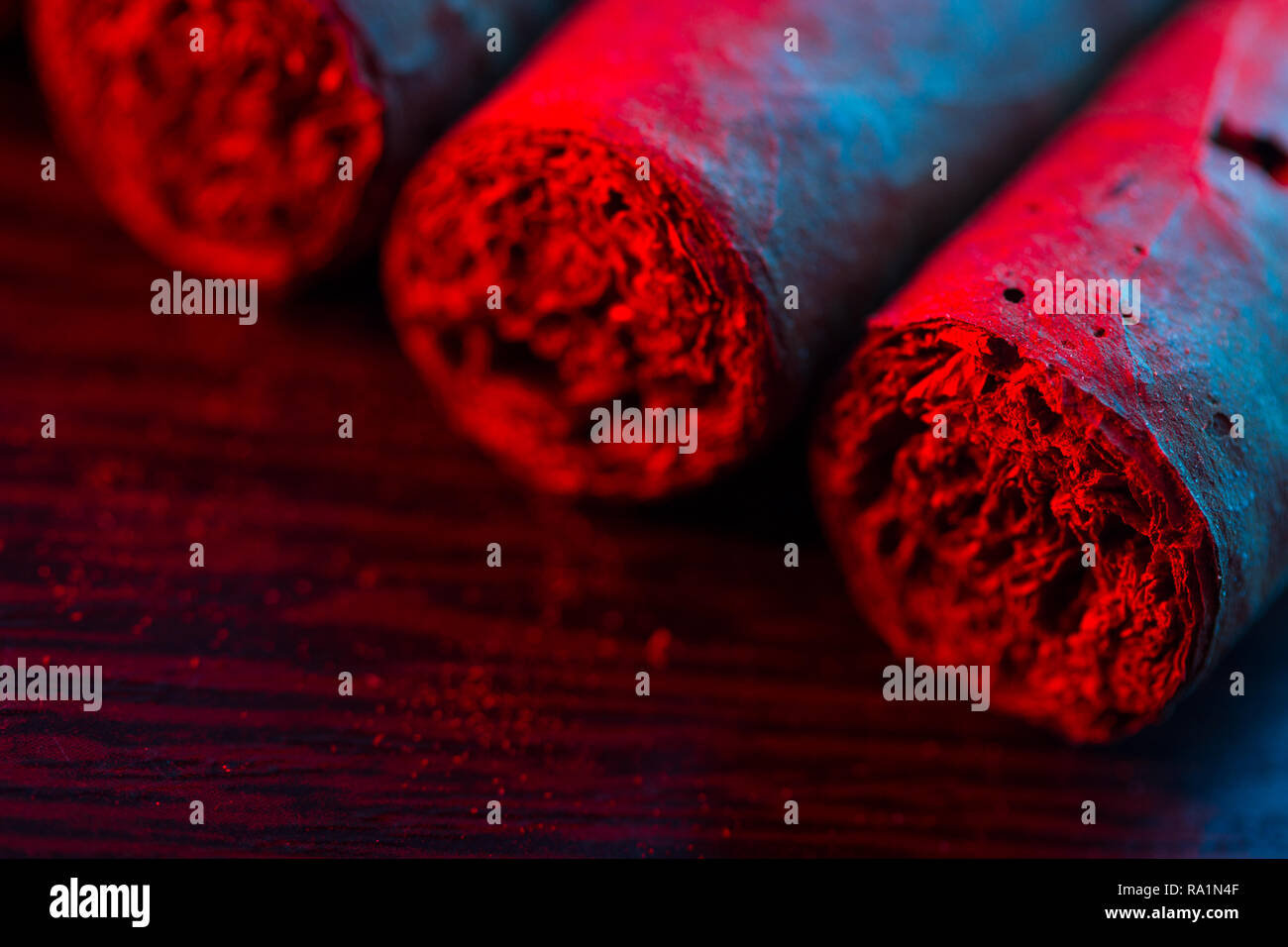 Close up of cigars in neon light Stock Photo - Alamy