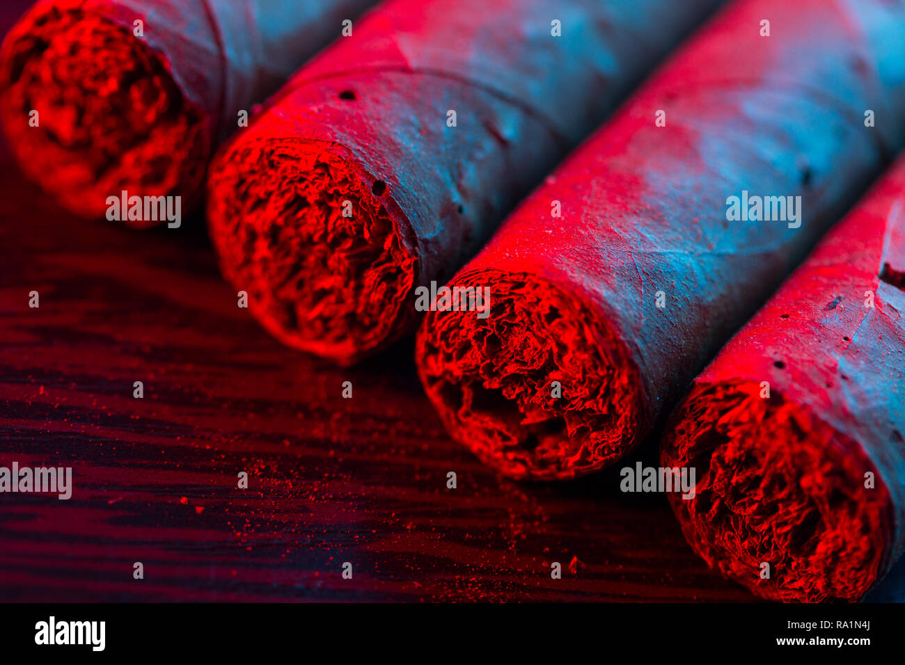 Close up of cigars in neon light Stock Photo - Alamy