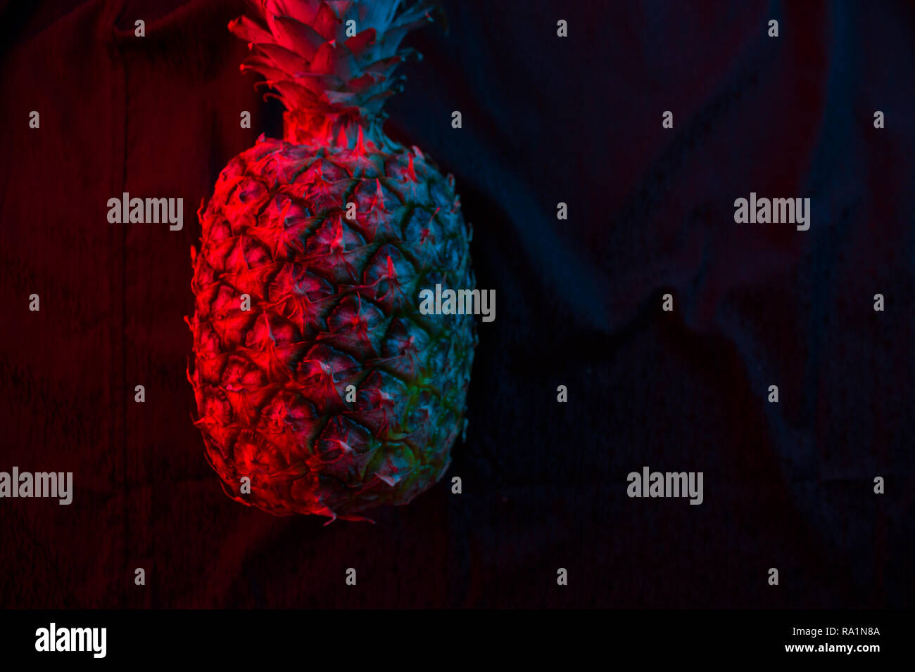 Pineapple in dark neon color on blackbackground Stock Photo - Alamy