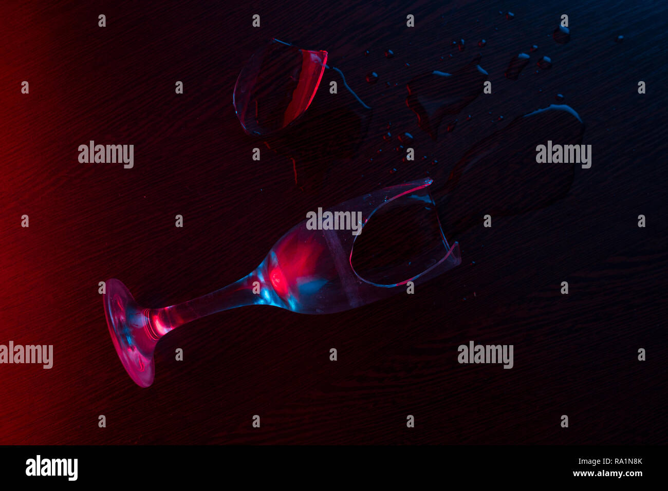 A glass breaking on the ground. neon light Stock Photo - Alamy