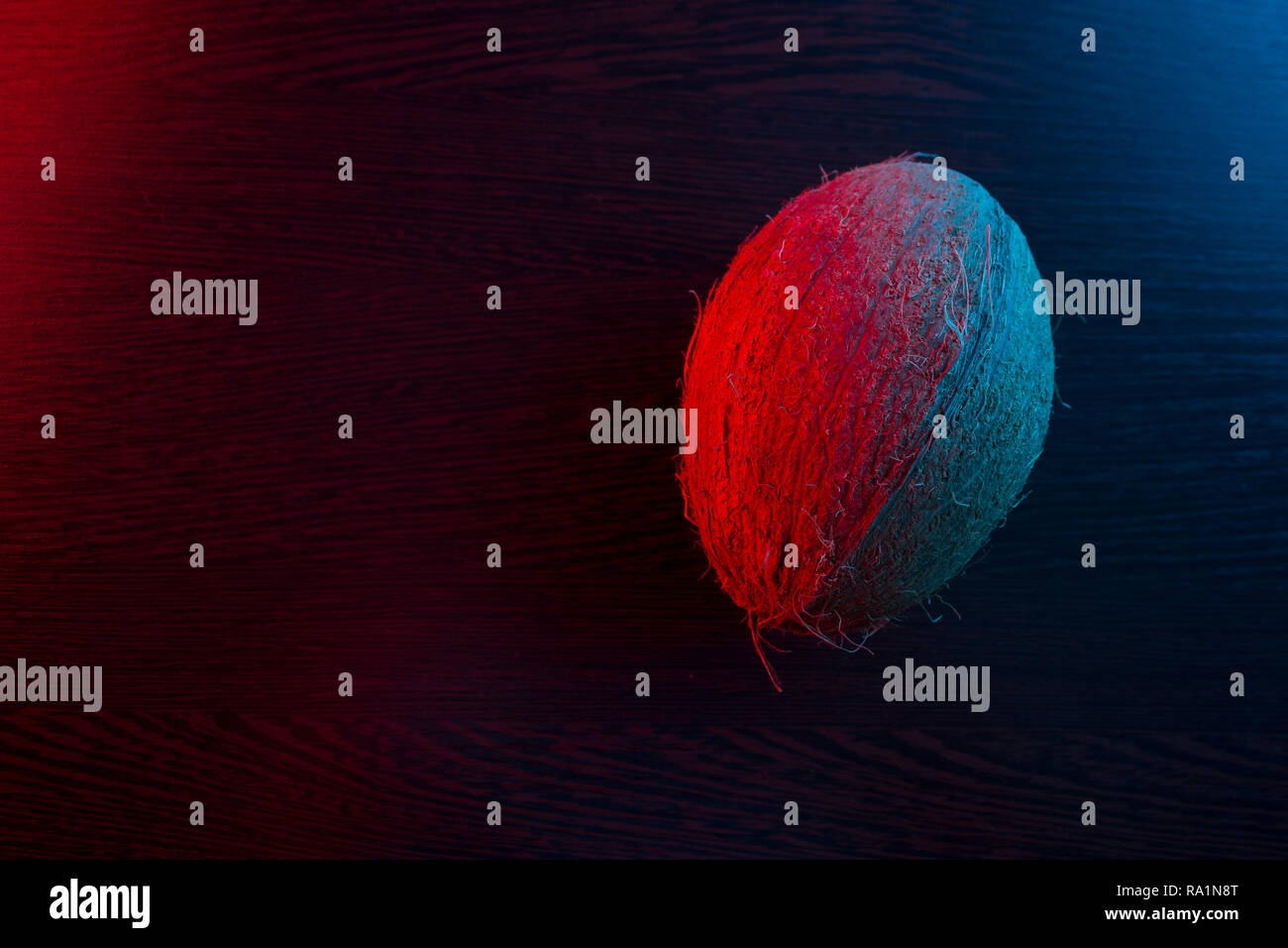 coconut on dark background in neon light Stock Photo - Alamy
