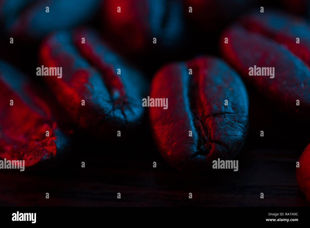 Roasted coffee bean close up in neon light Stock Photo - Alamy