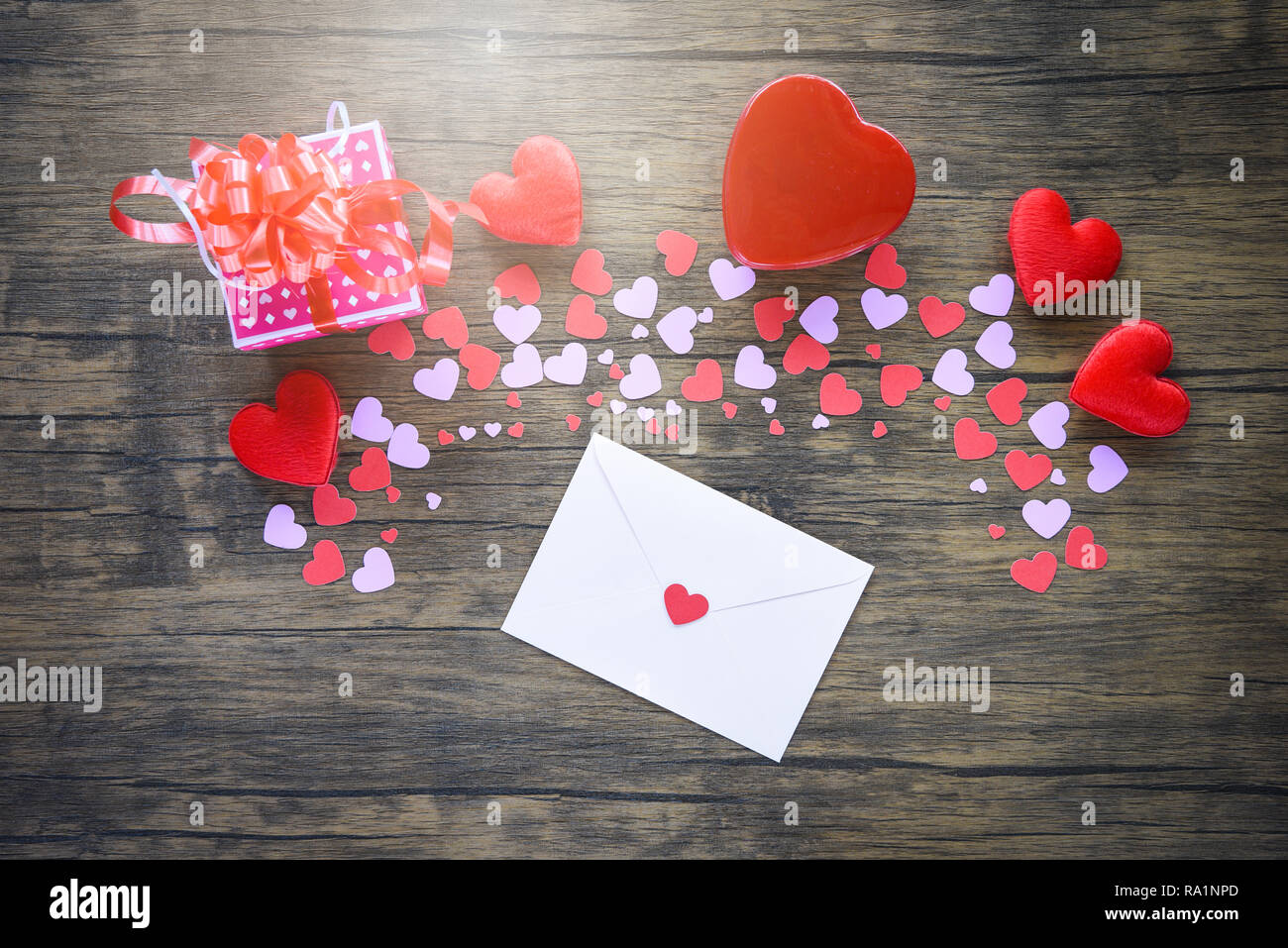 Paper Heart and gift box on wooden background / Various sizes pink and ...