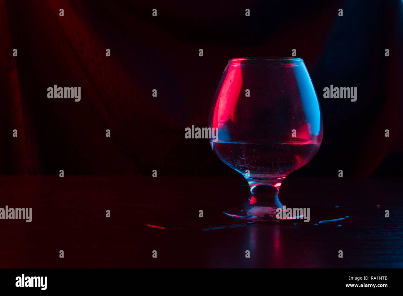 glass with alcohol in neon light in a bar or club Stock Photo - Alamy