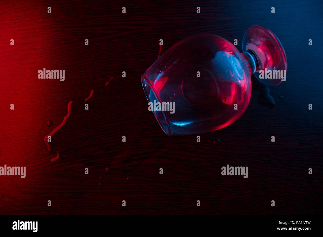 alcohol split from glass. on dark background Stock Photo - Alamy