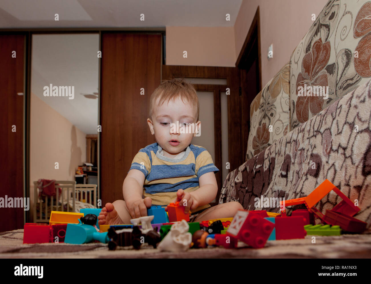 Sweet little boy building tower from cubes at home Stock Photo - Alamy