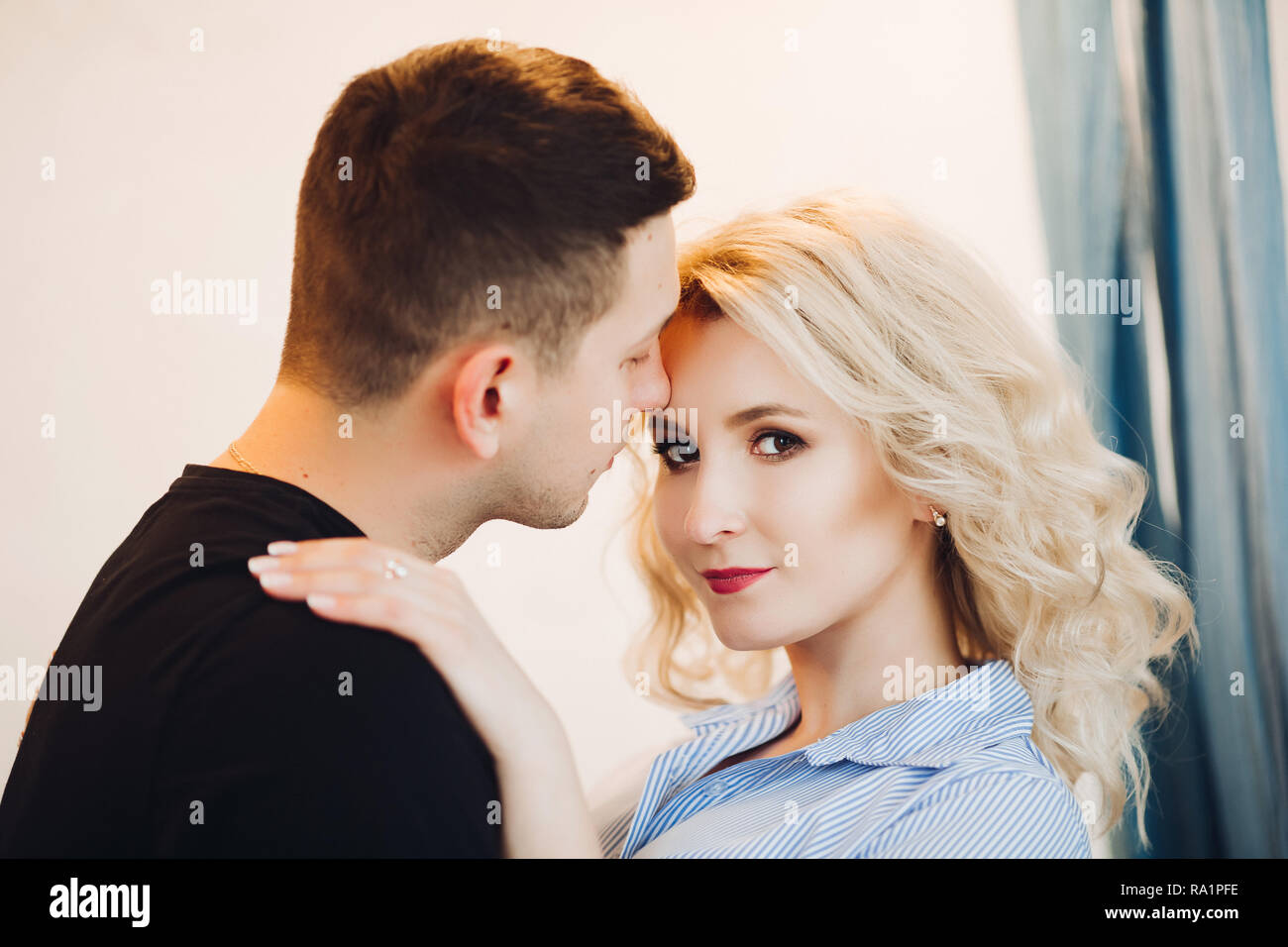 Couple embracing each other and touching face to face Stock Photo - Alamy
