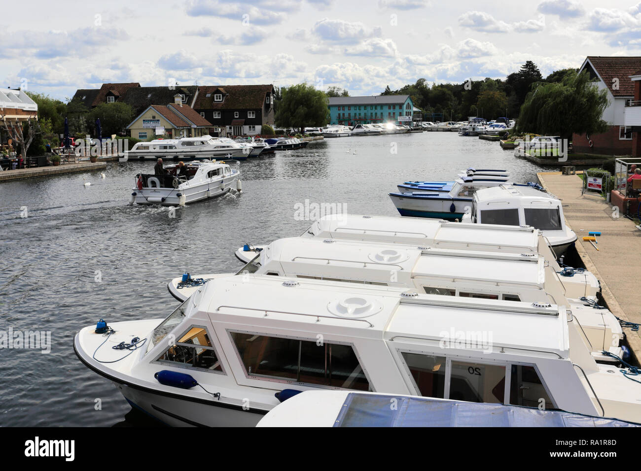 Pleasure boats on the River Bure at Wroxham town in the Norfolk Broads ...